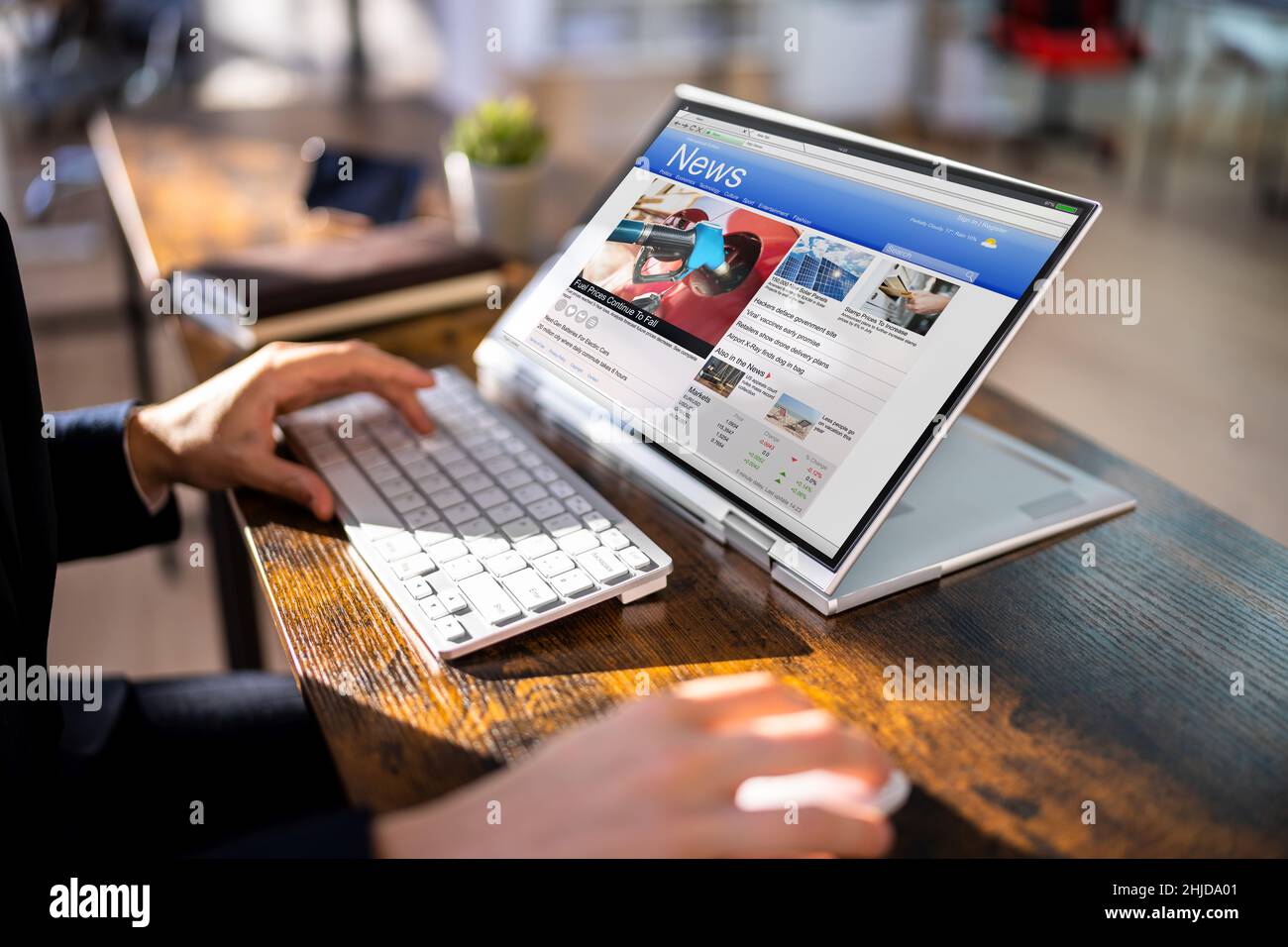 Man reading newspaper working laptop hi-res stock photography and ...