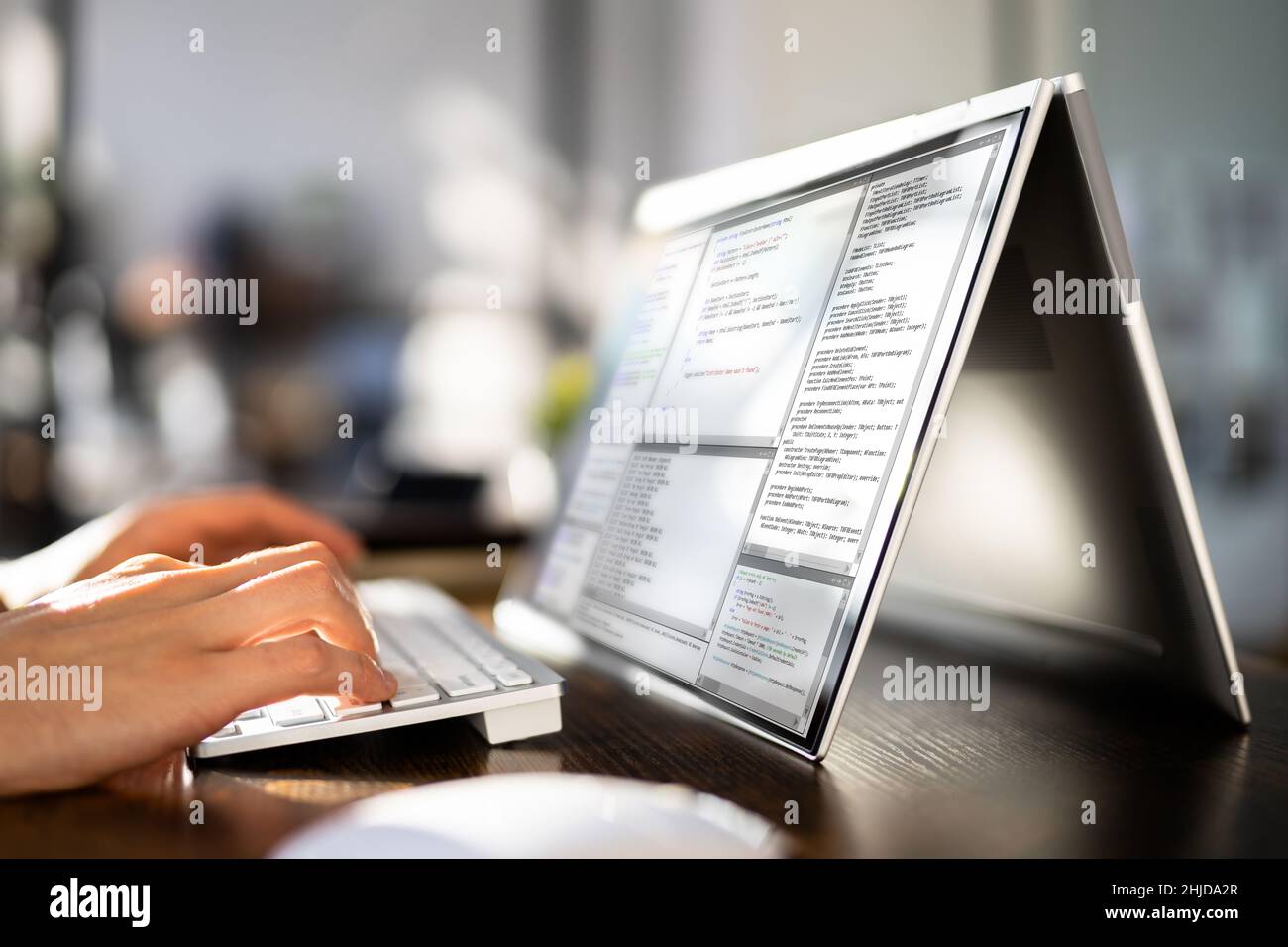 Programmer Or Coder At Office Desk Using Laptop Stock Photo - Alamy
