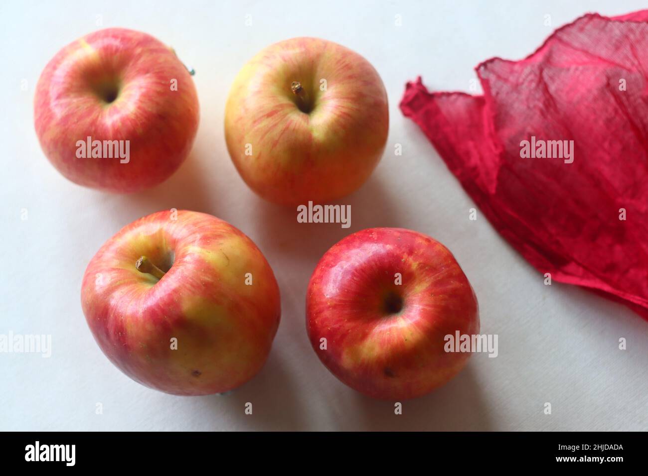 A crop of red fresh juicy apples, randomly placed and shot on white ...