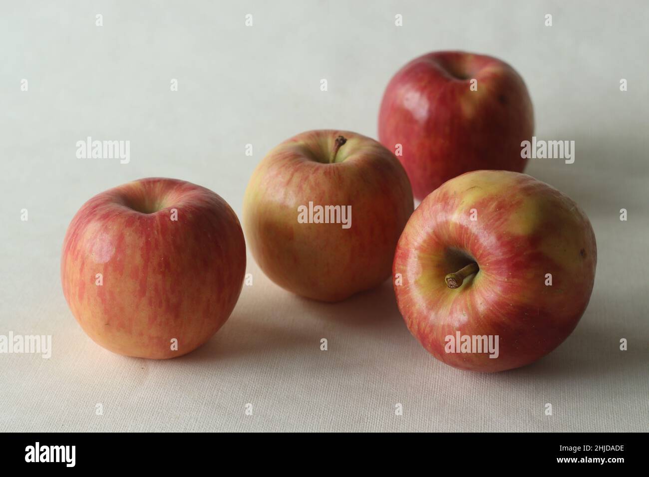 A crop of red fresh juicy apples, randomly placed and shot on white ...
