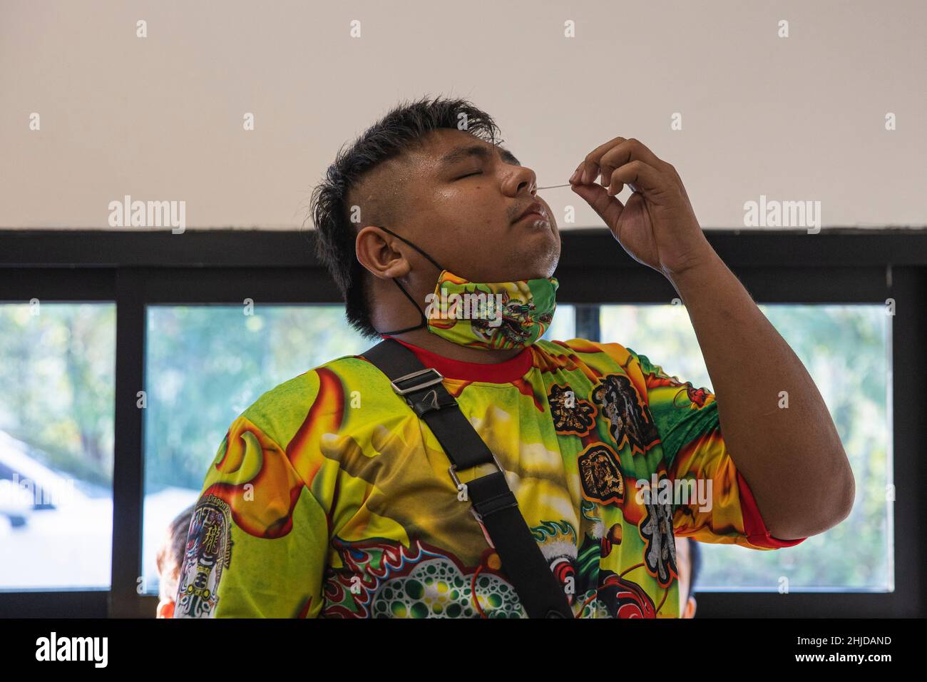 Long Qian dragon and lion dancer takes an ATK nasal swab test before ...