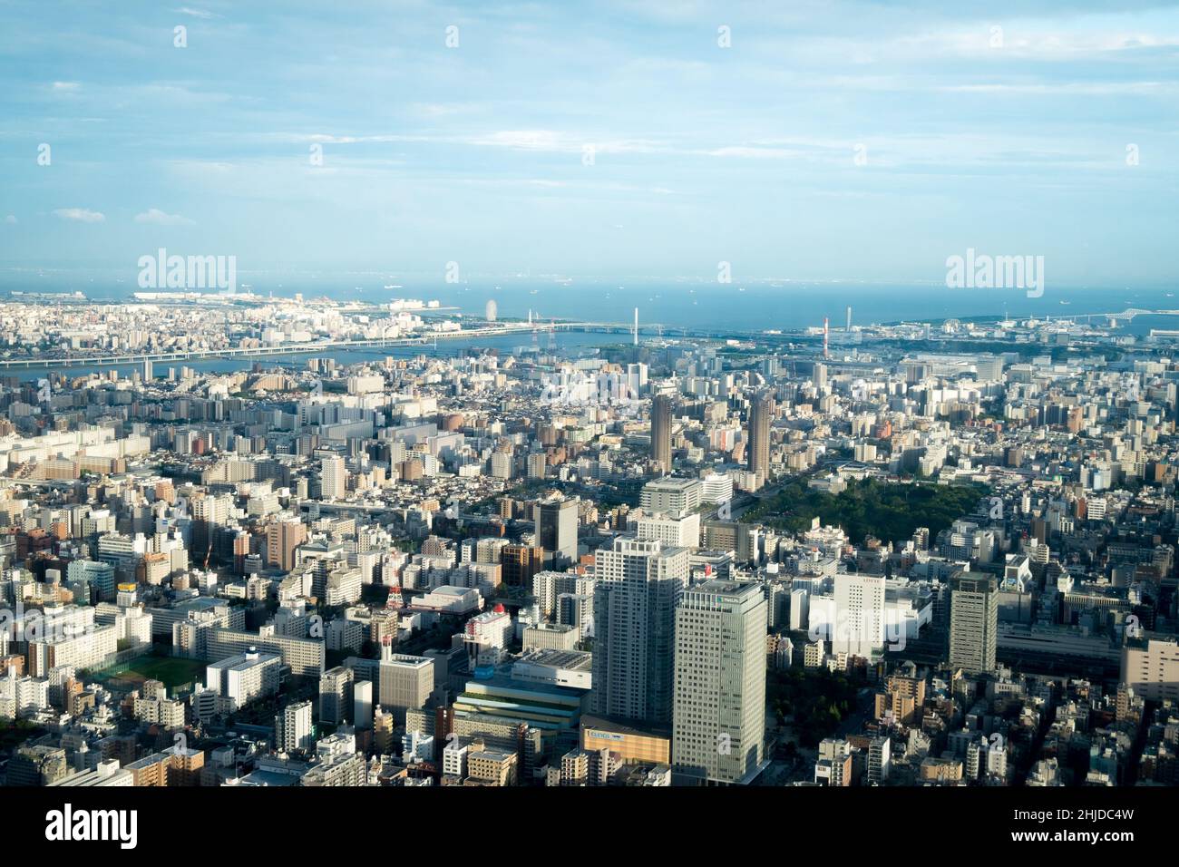 Cityscape of Tokyo from above in the afternoon with sun rays shining on ...