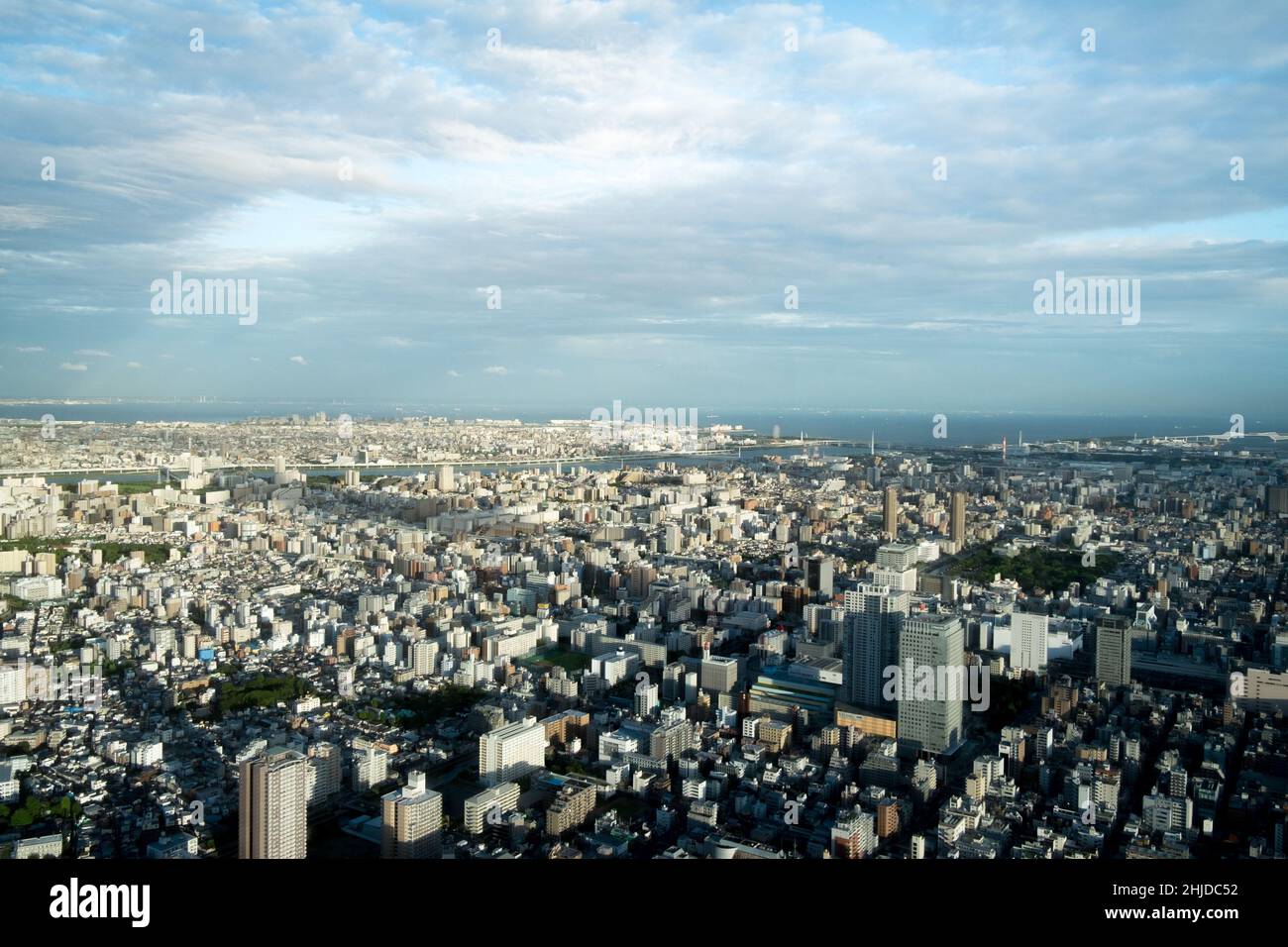 Cityscape of Tokyo from above in the afternoon with sun rays shining on ...