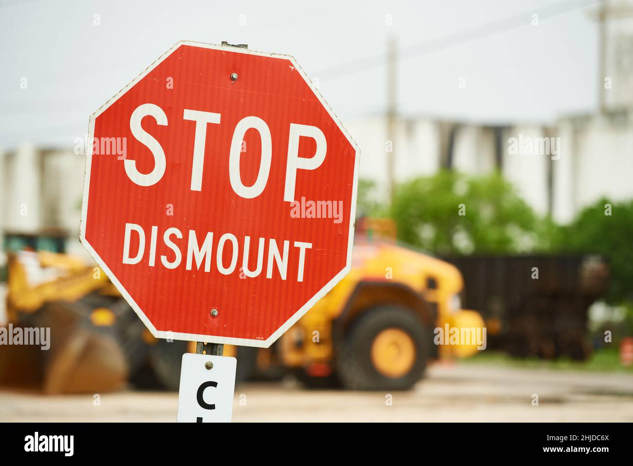 Stop and dismount road sign Stock Photo - Alamy