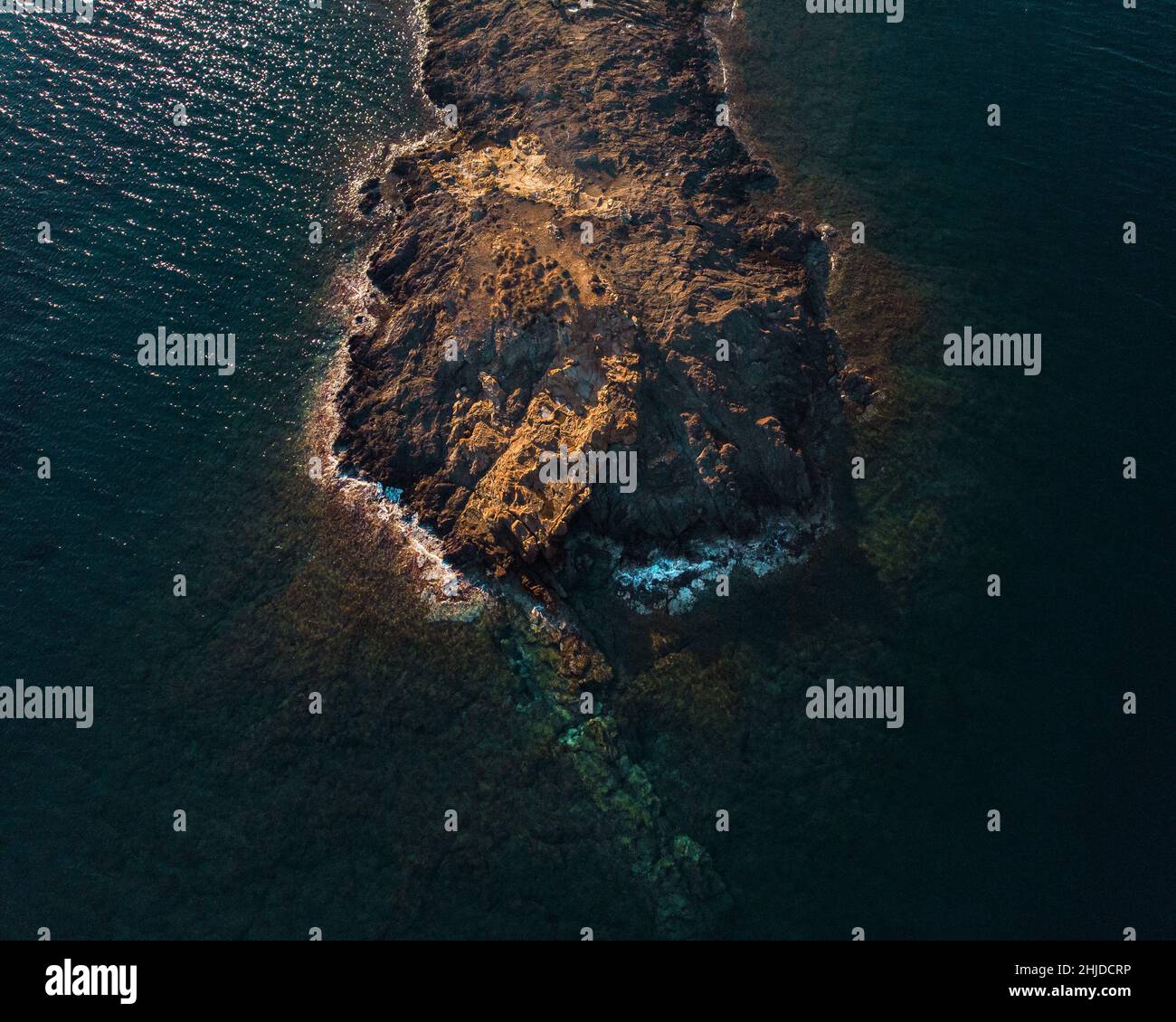 Bird's eye view of a rock peninsula being washed by ocean waves Stock ...