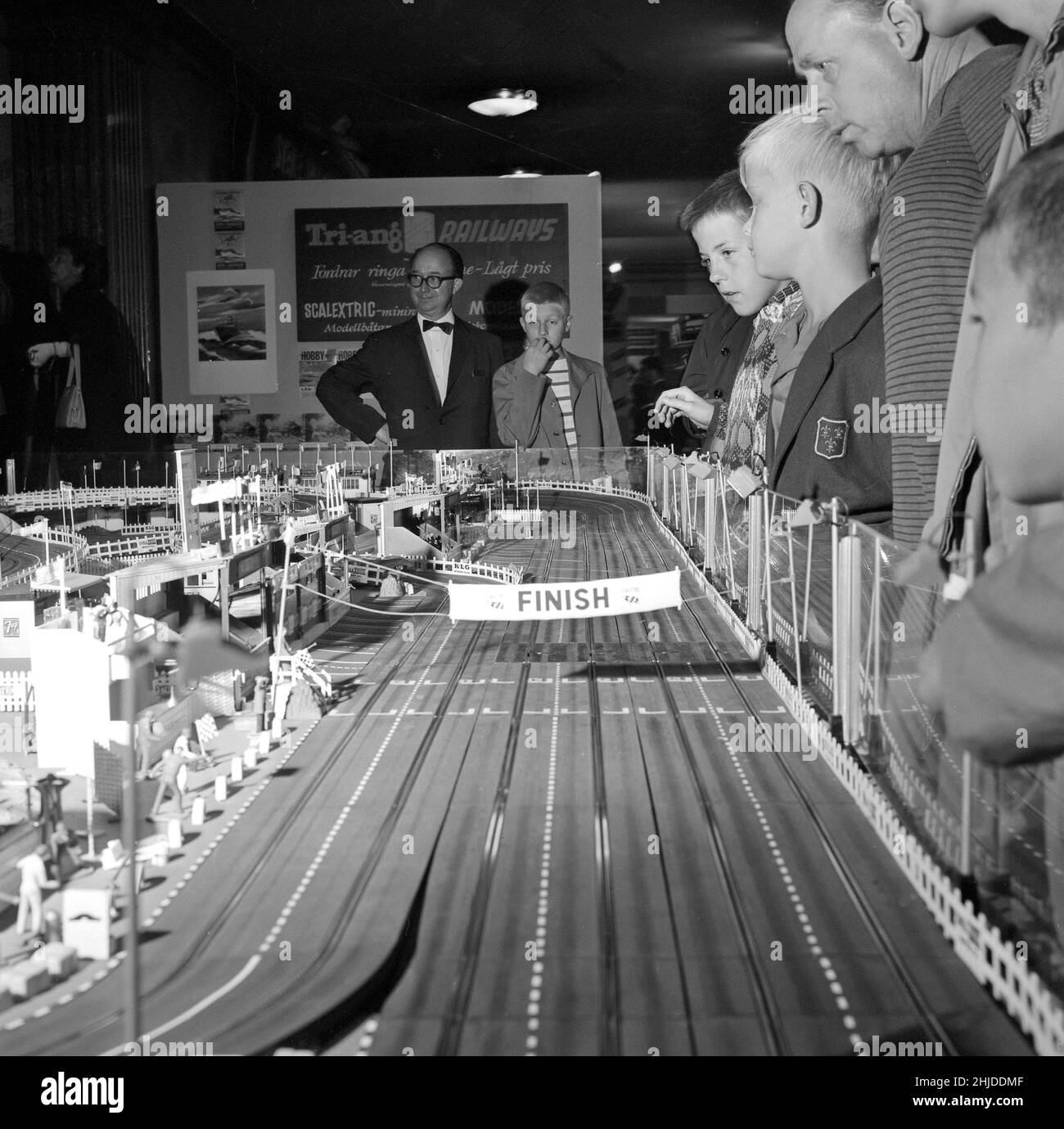 Toys in the 1960s. A boy fascinated by a miniature racing track by ...