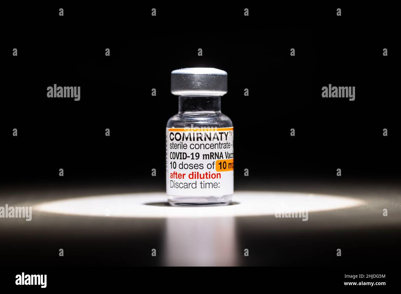 In this photo illustration a vial of COMIRNATY (Pfizer BioNTech ...