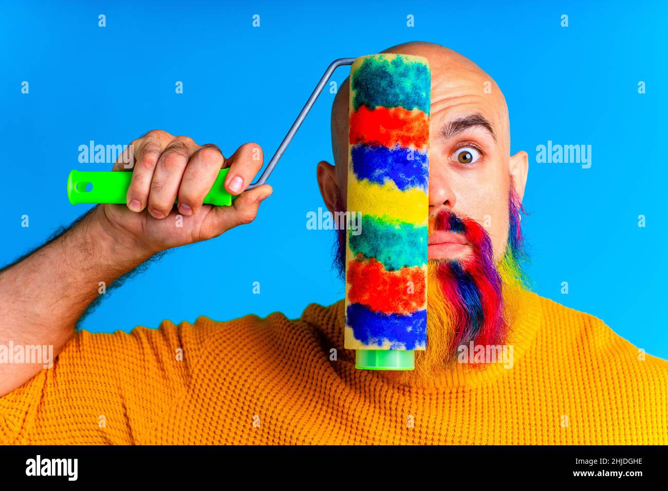 bold man paint beard in multicolors in blue studio background Stock ...