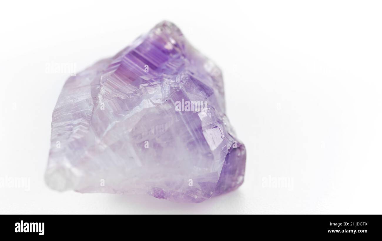 Amethyst macro photography. Purple translucent stone on a white ...