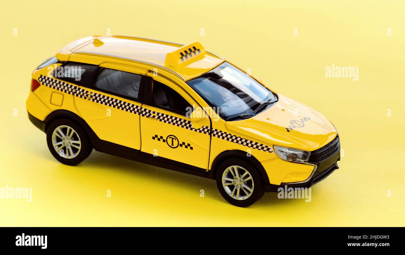 Yellow taxi cab on a yellow background macro photography. Taxi car side ...