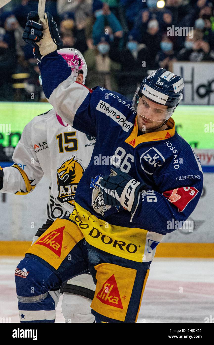 Marco Mueller #86 (EV Zug) stretches his stick in the air cheering ...