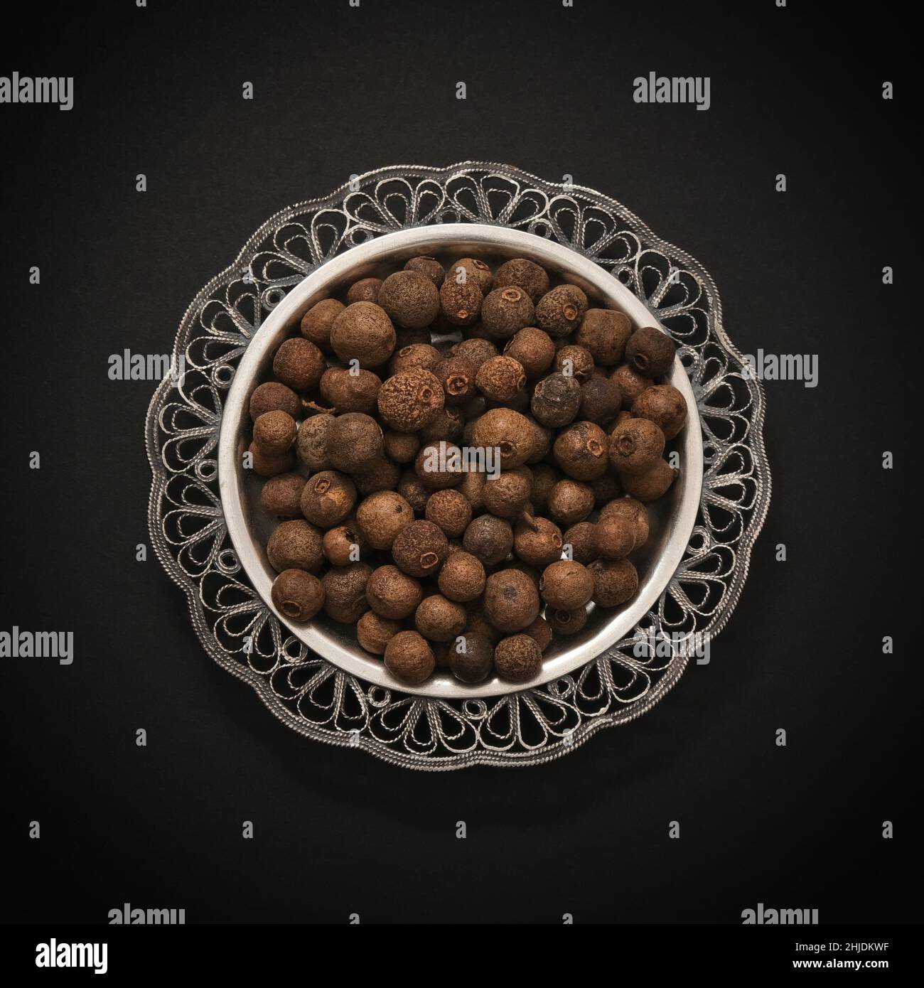 Pile of dried ripe pepper berries allspice pepper peas close-up in ...