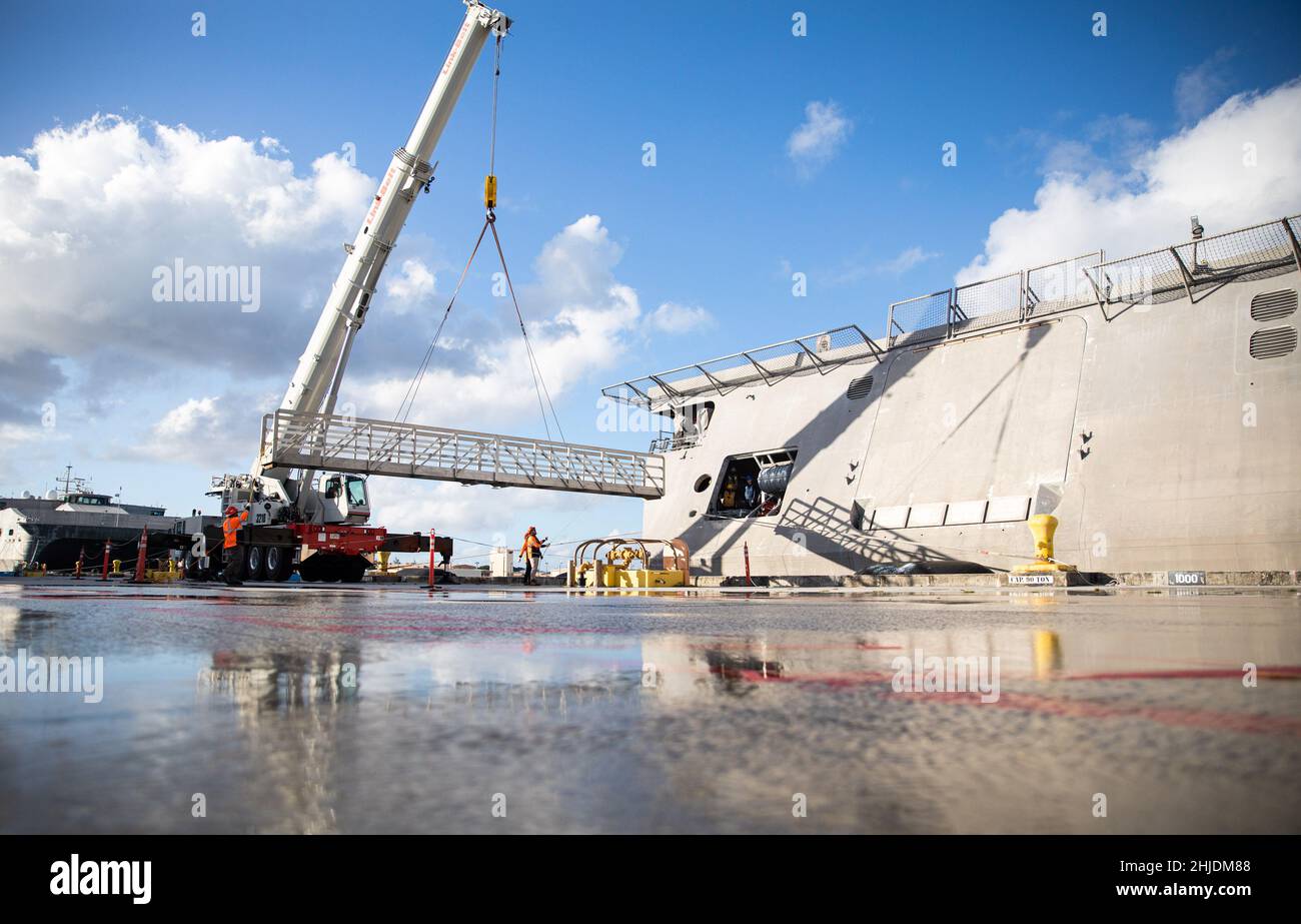 220126-N-LI768-2054 APRA HARBOR, Guam (Jan. 26, 2022) – A crane lifts a ...