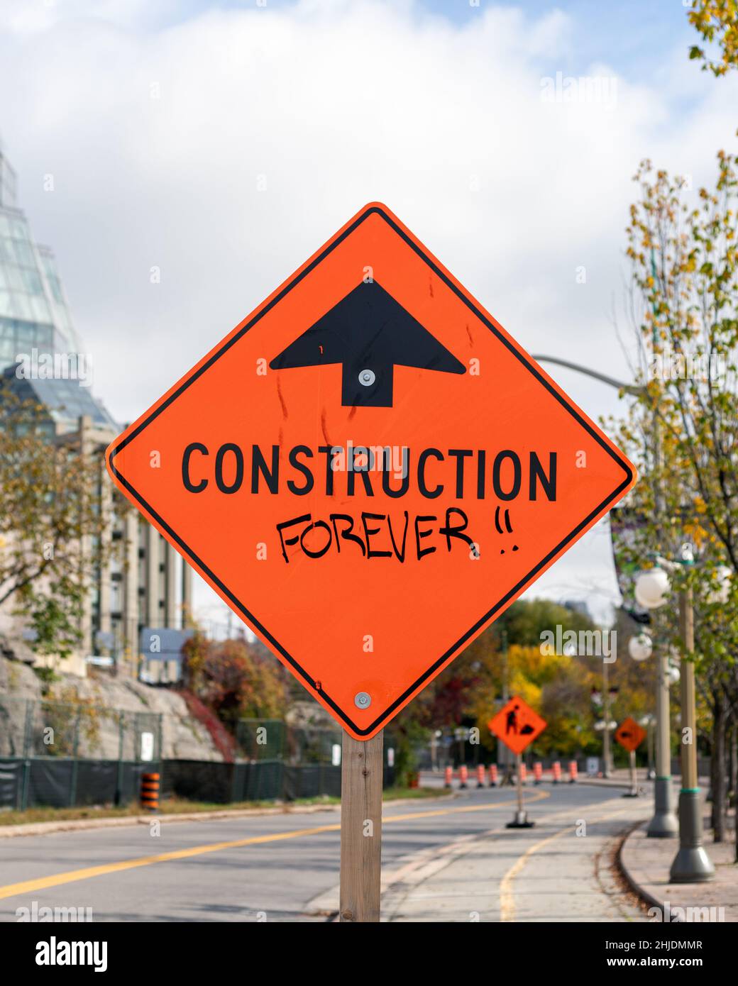 Construction ahead orange road sign in the street of downtown Ottawa ...