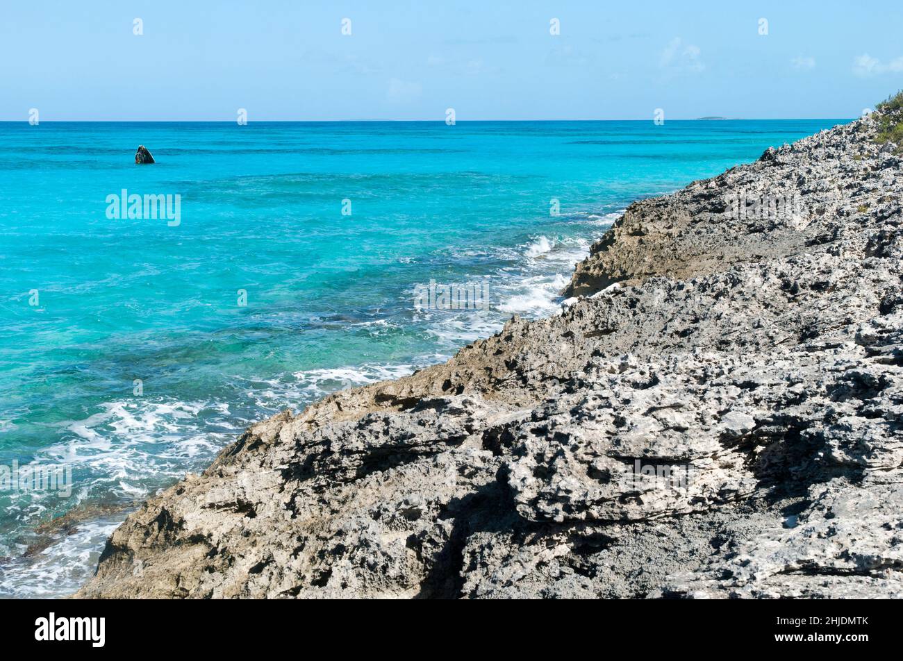 The sharp eroded coastline and turquoise color waters on Half Moon Cay ...