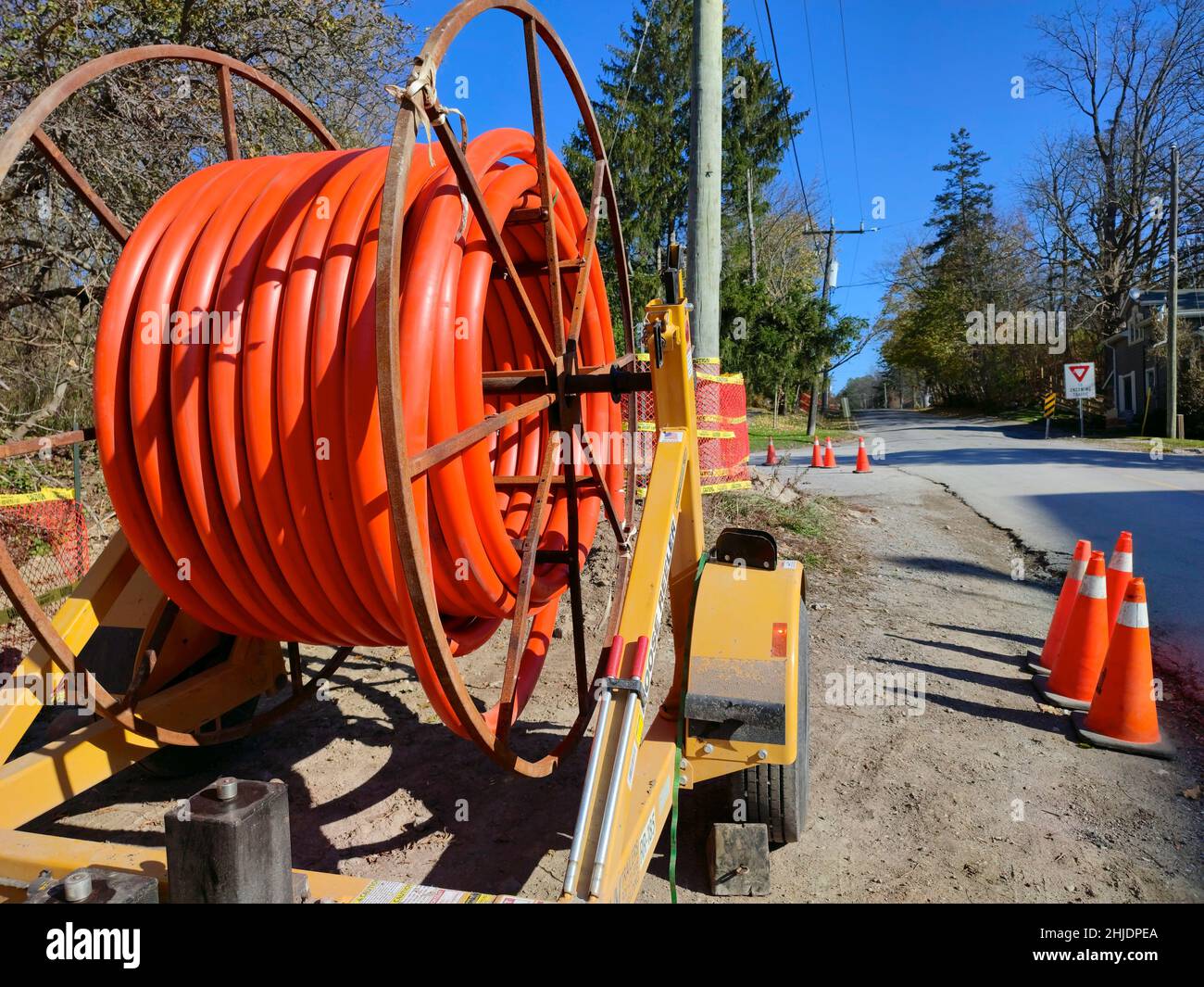 Orange pipes for fiber optics in a city road construction to connect ...
