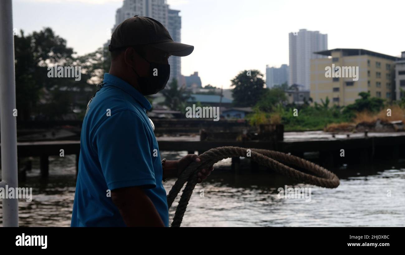 Orange Flag Express Boat Worker lassoing, tethering, tying and docking ...