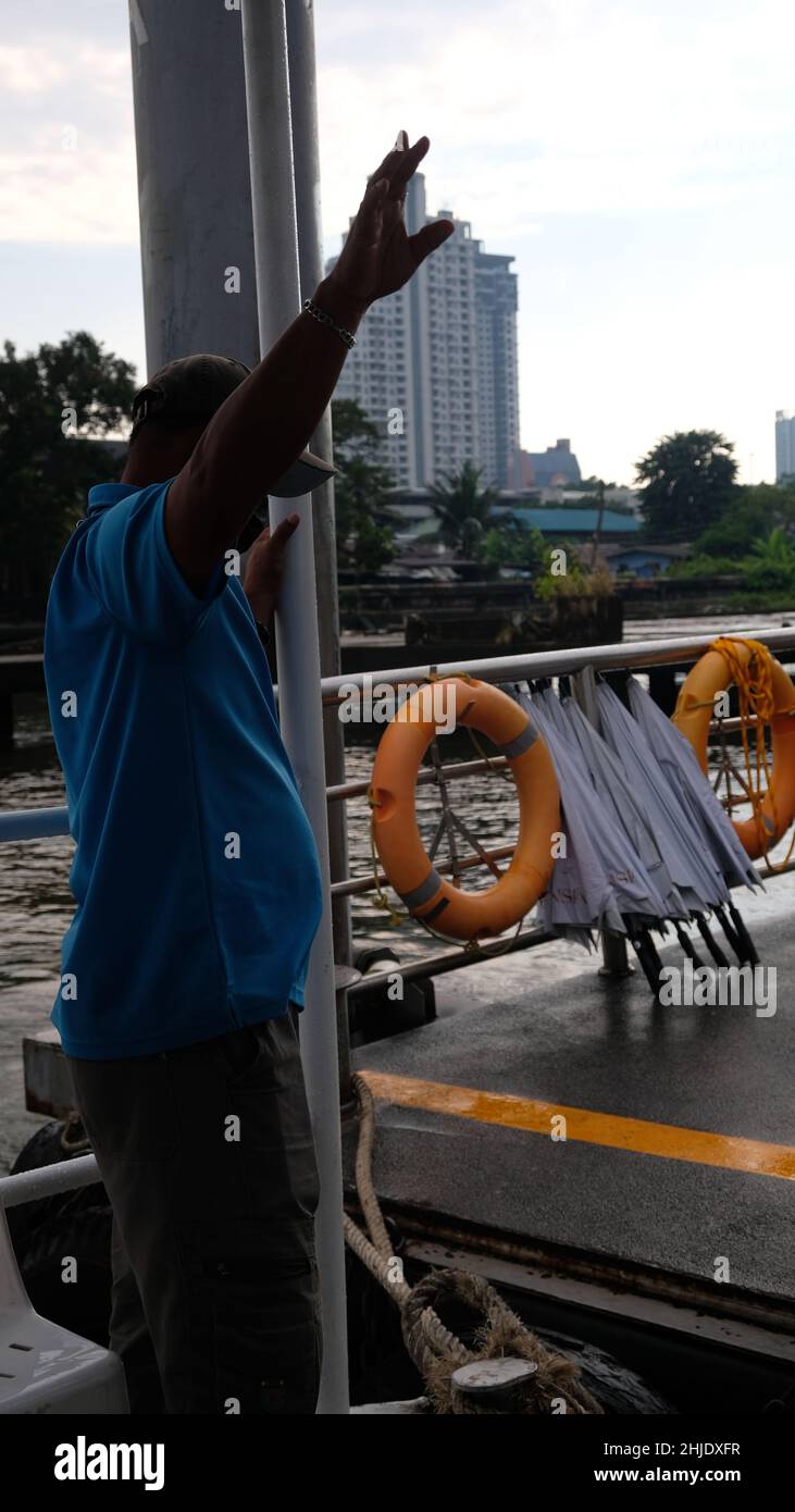 Orange Flag Express Boat Worker lassoing, tethering, tying and docking ...