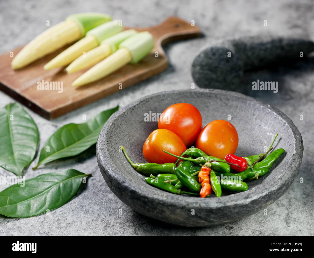 cayenne pepper and tomatoes in a stone mortar. tomato sauce recipe ...