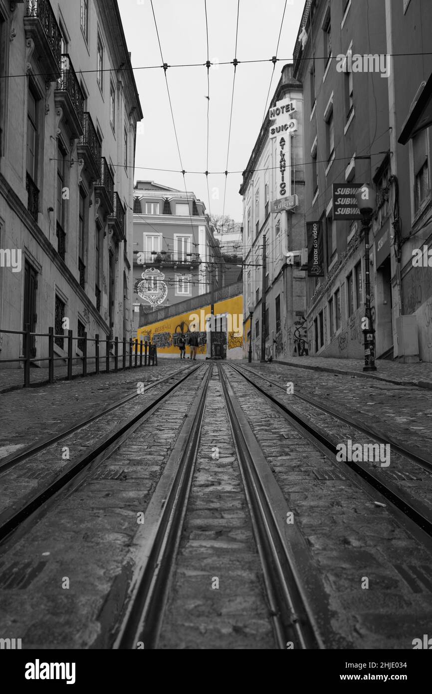 Vertical grayscale shot of railways surrounded by buildings Stock Photo ...