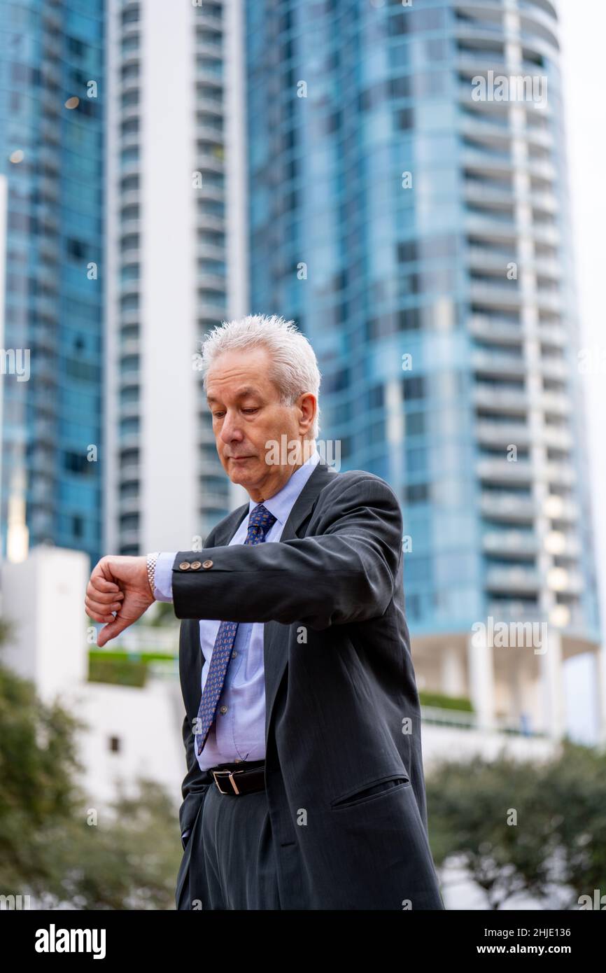 Checking the time on his watch hi-res stock photography and images - Alamy