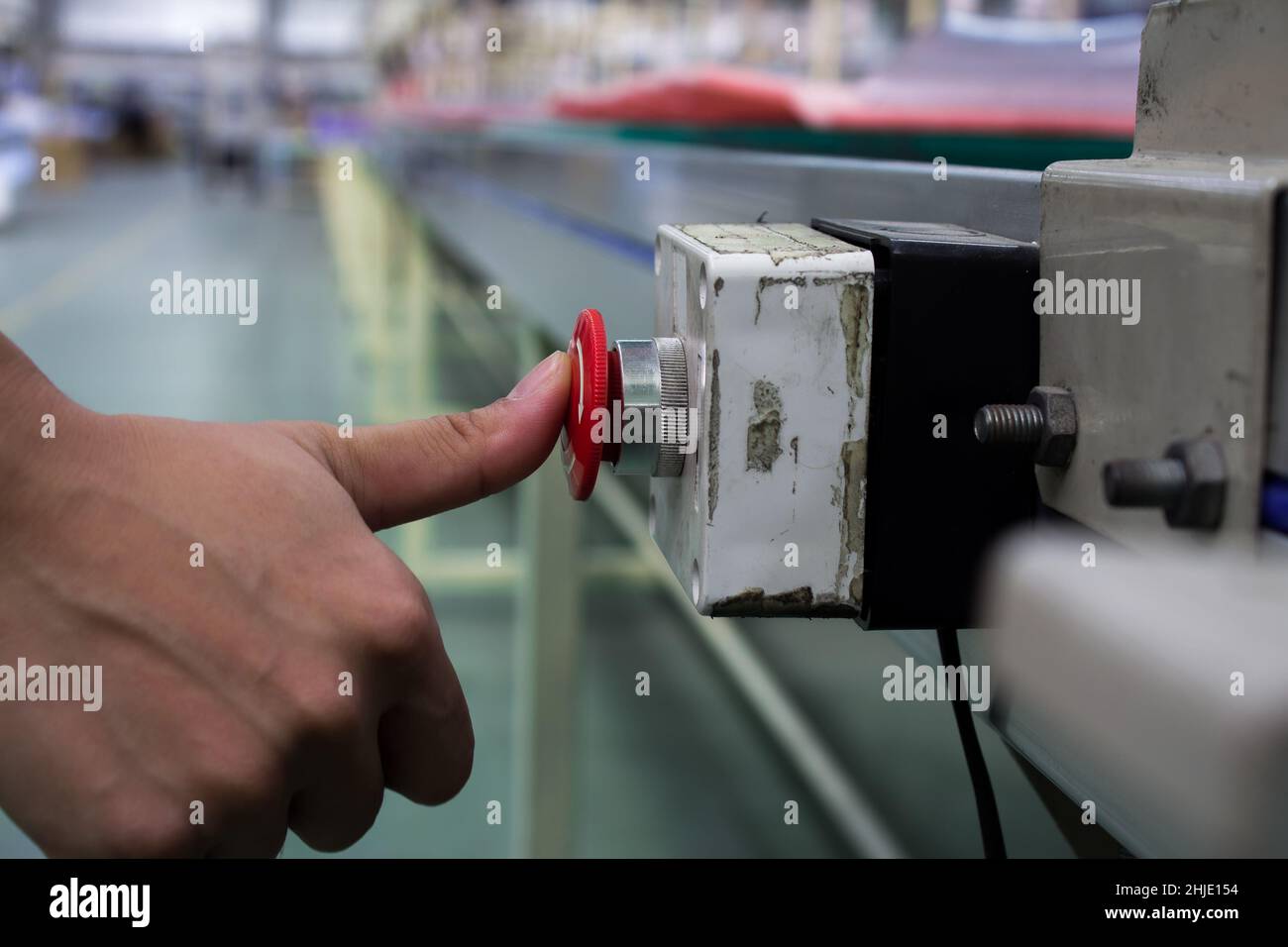 Male hand pushing emergency red stop button Stock Photo - Alamy