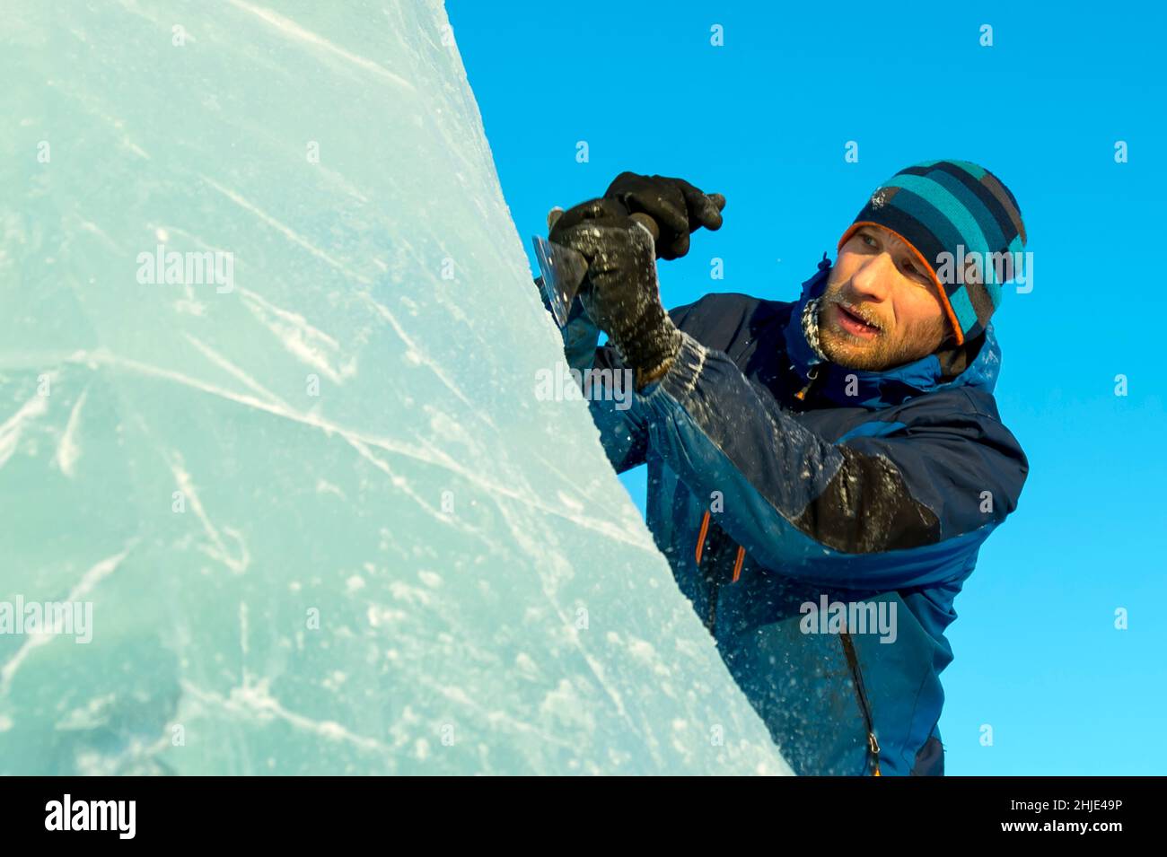 The sculptor cuts an ice figure out of a block of ice for Christmas ...