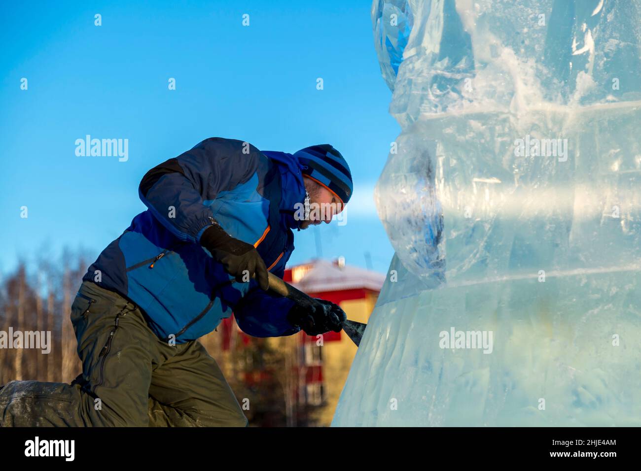 The sculptor cuts an ice figure out of a block of ice for Christmas ...