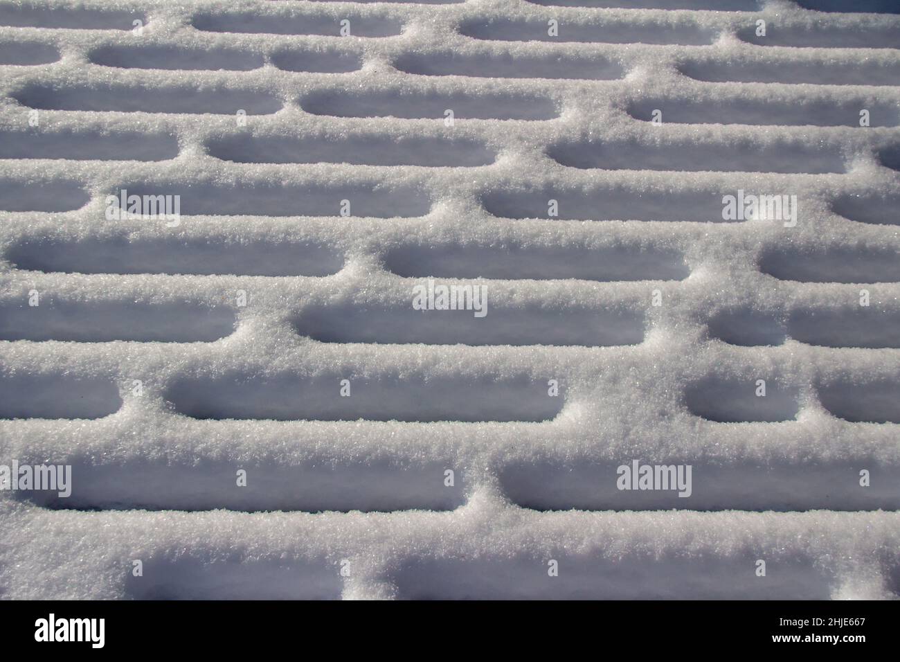 Full frame closeup abstract texture background of snow designs on a ...