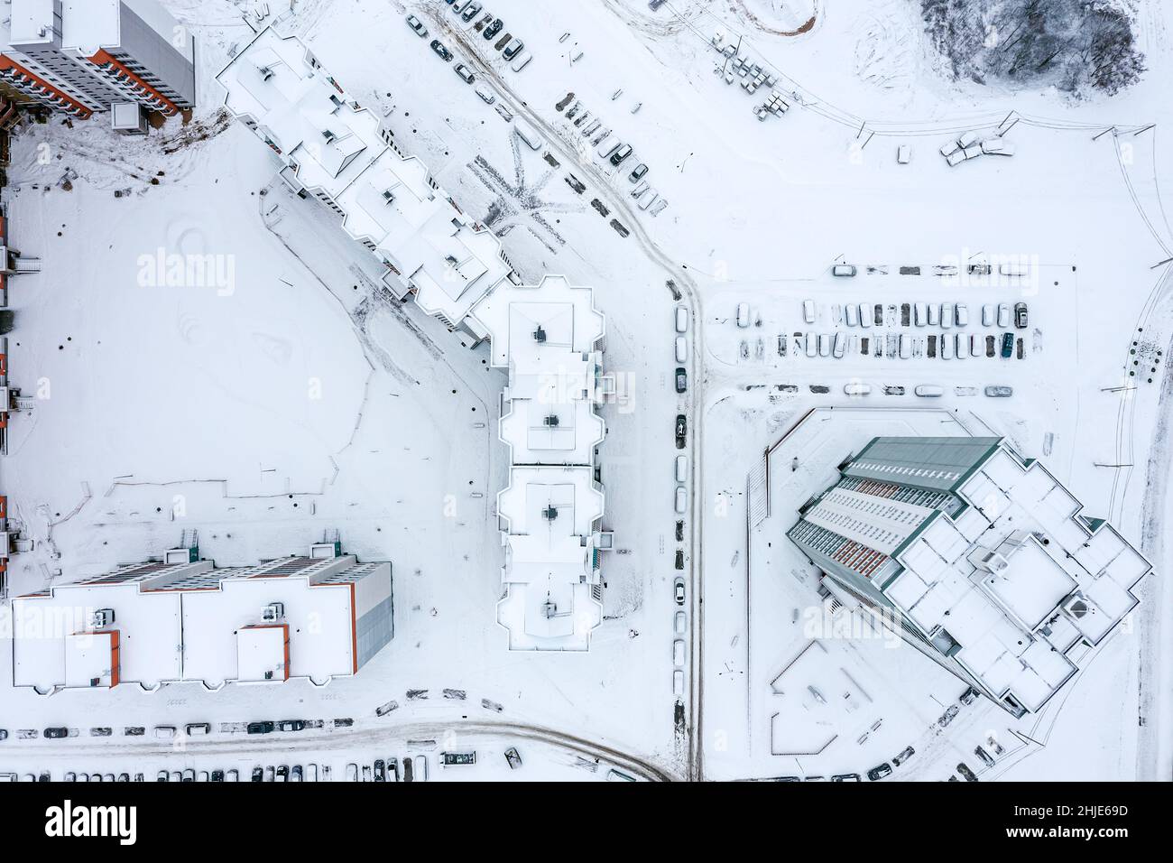 courtyard of apartment buildings complex after snowfall. rooftops and ...
