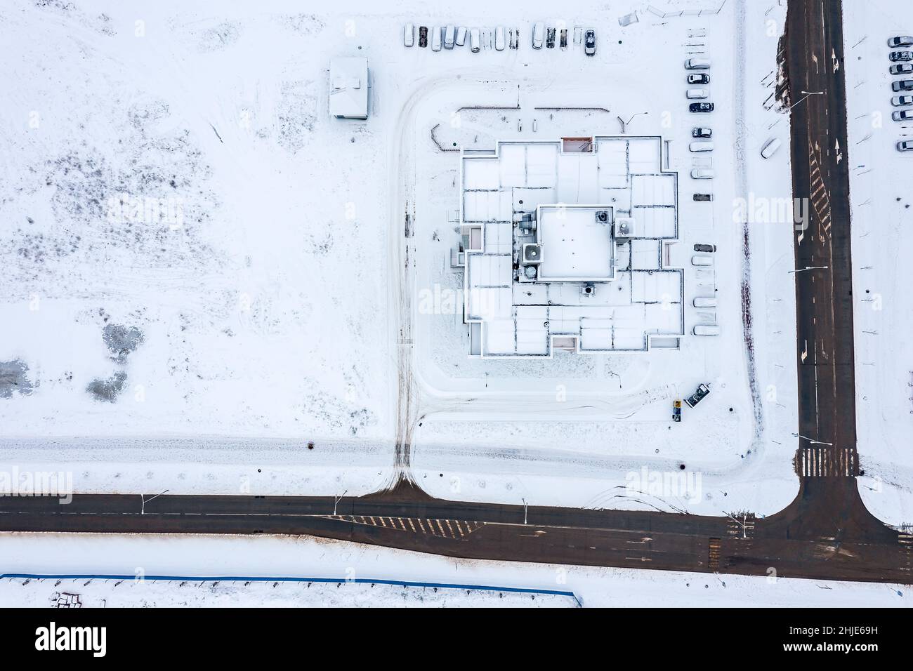 snowy roof of a high-rise apartment building, newly constructed in ...