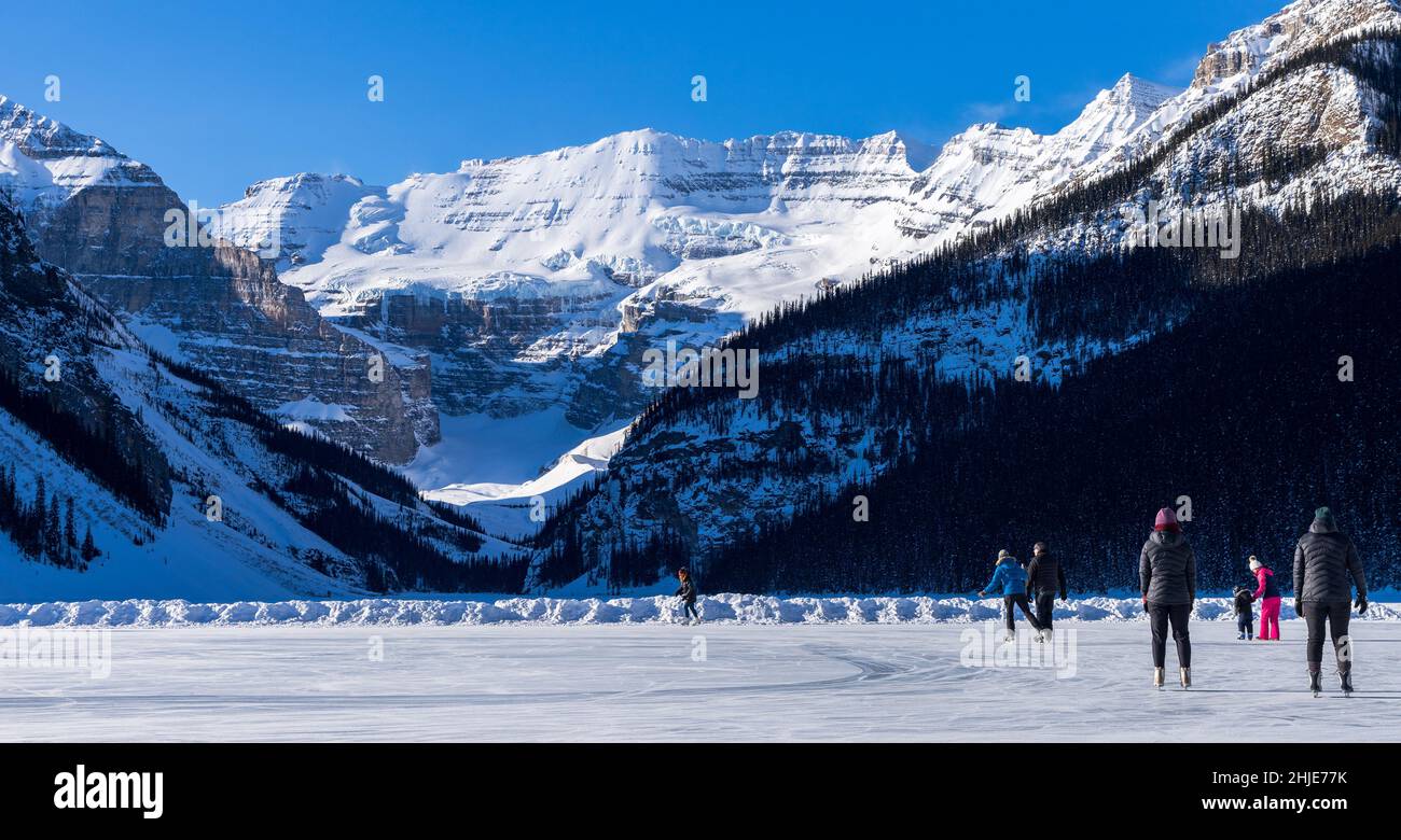 Tourists skating on Lake Louise winter ice skating rink. Banff National ...