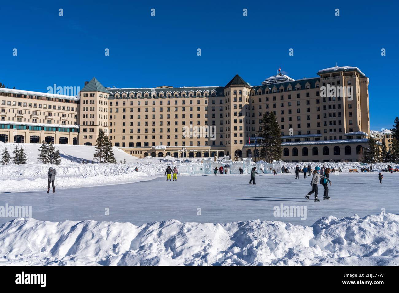 Tourists skating on Lake Louise winter ice skating rink. Banff National ...