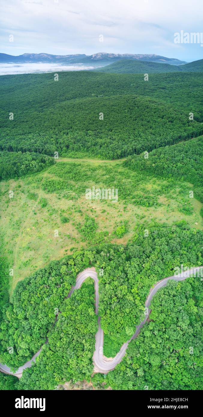Road serpentine in mountain. Aerial nature scene Stock Photo - Alamy
