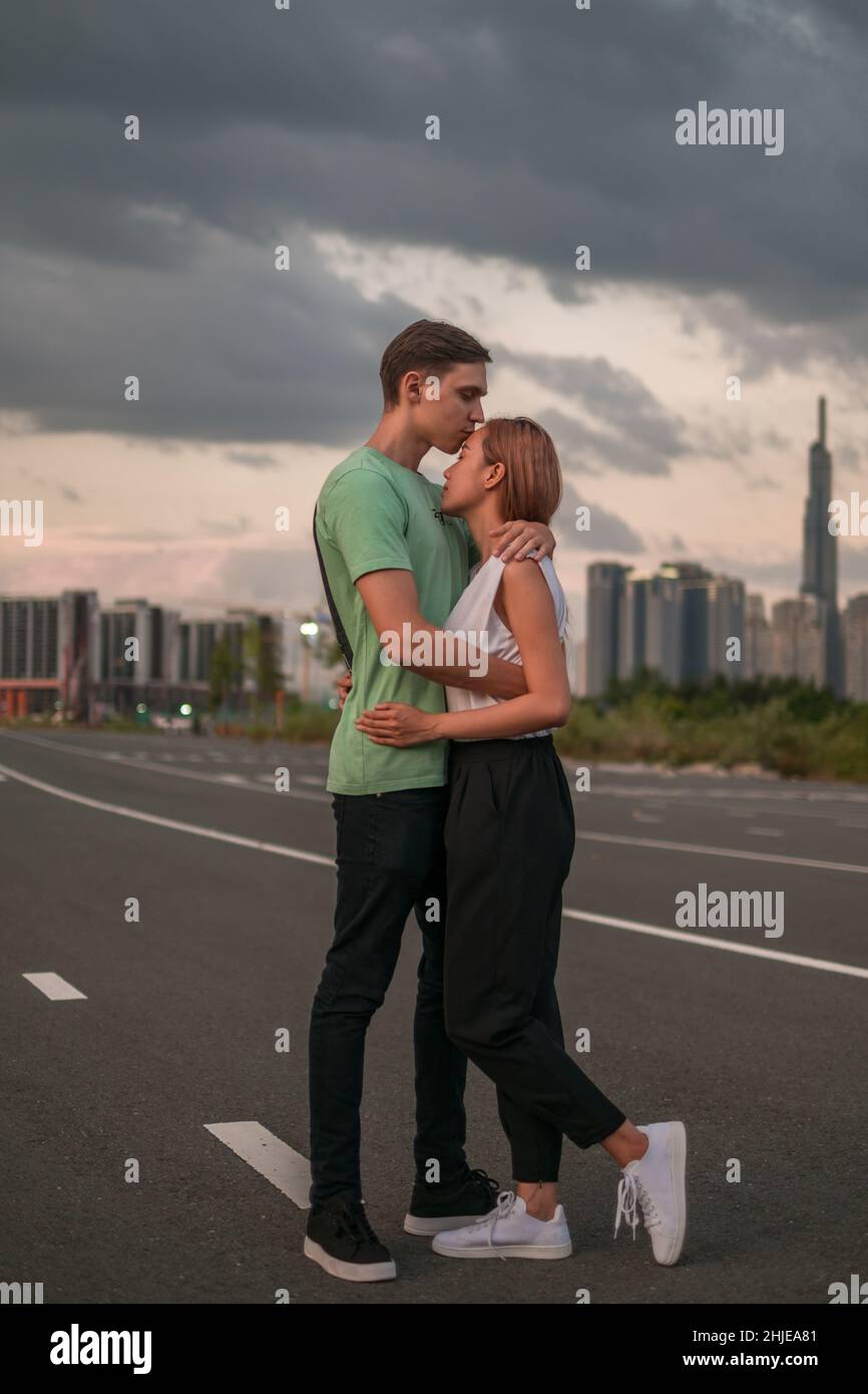 Lovely young couple standing on the street in the metropolis on the ...