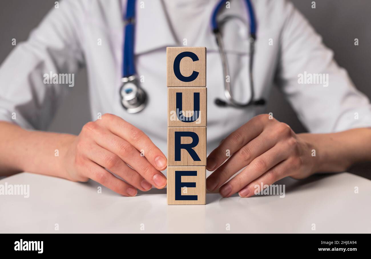 Word cure in doctor hands on paper. Medical concept Stock Photo - Alamy