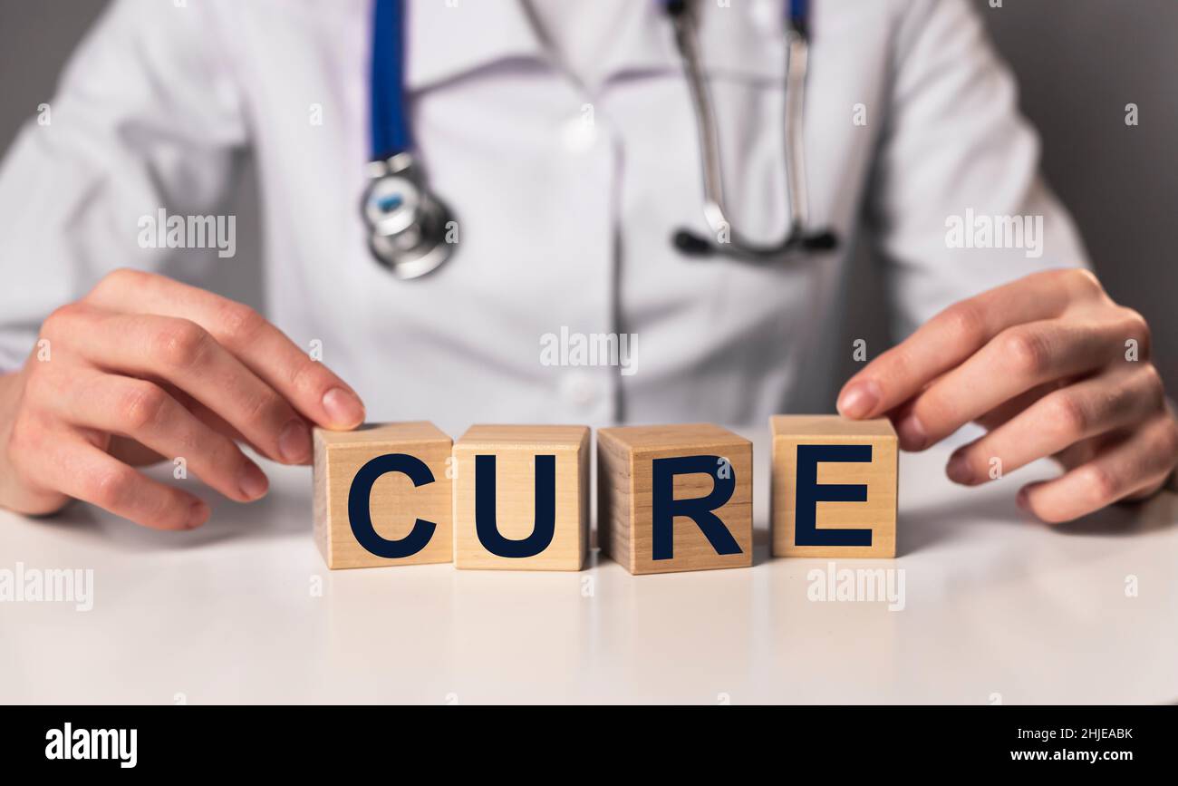 Word cure in doctor hands on paper. Medical concept Stock Photo - Alamy