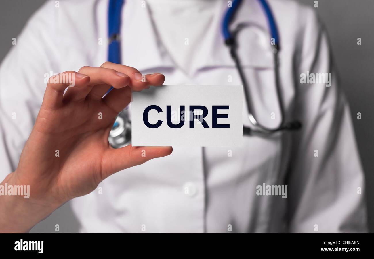 Word cure in doctor hands on paper. Medical concept Stock Photo - Alamy