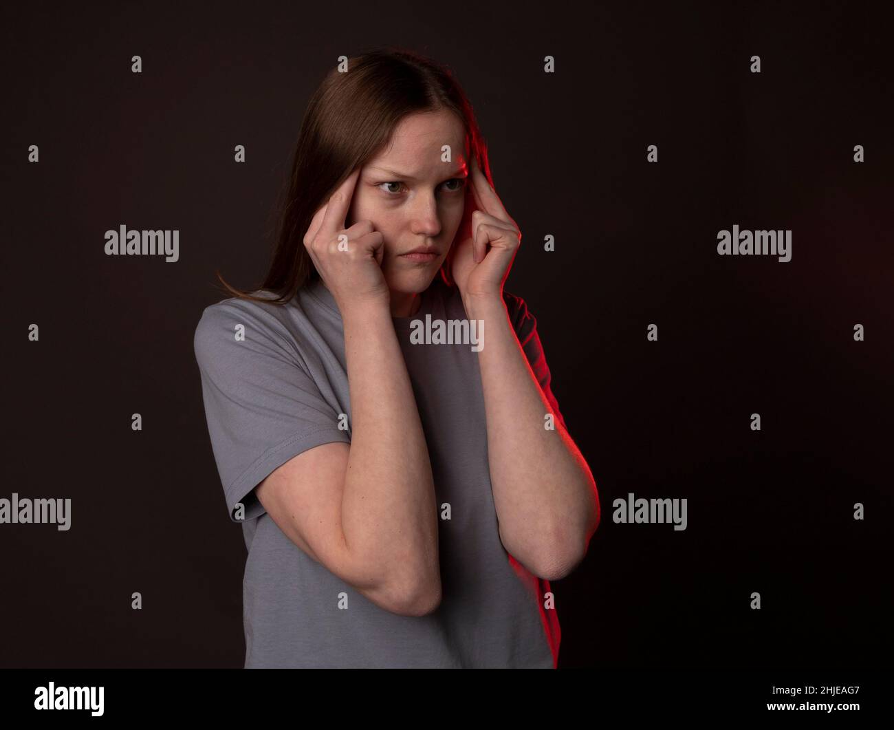 Young woman with heavy sharp headache, holding her temples with pain ...
