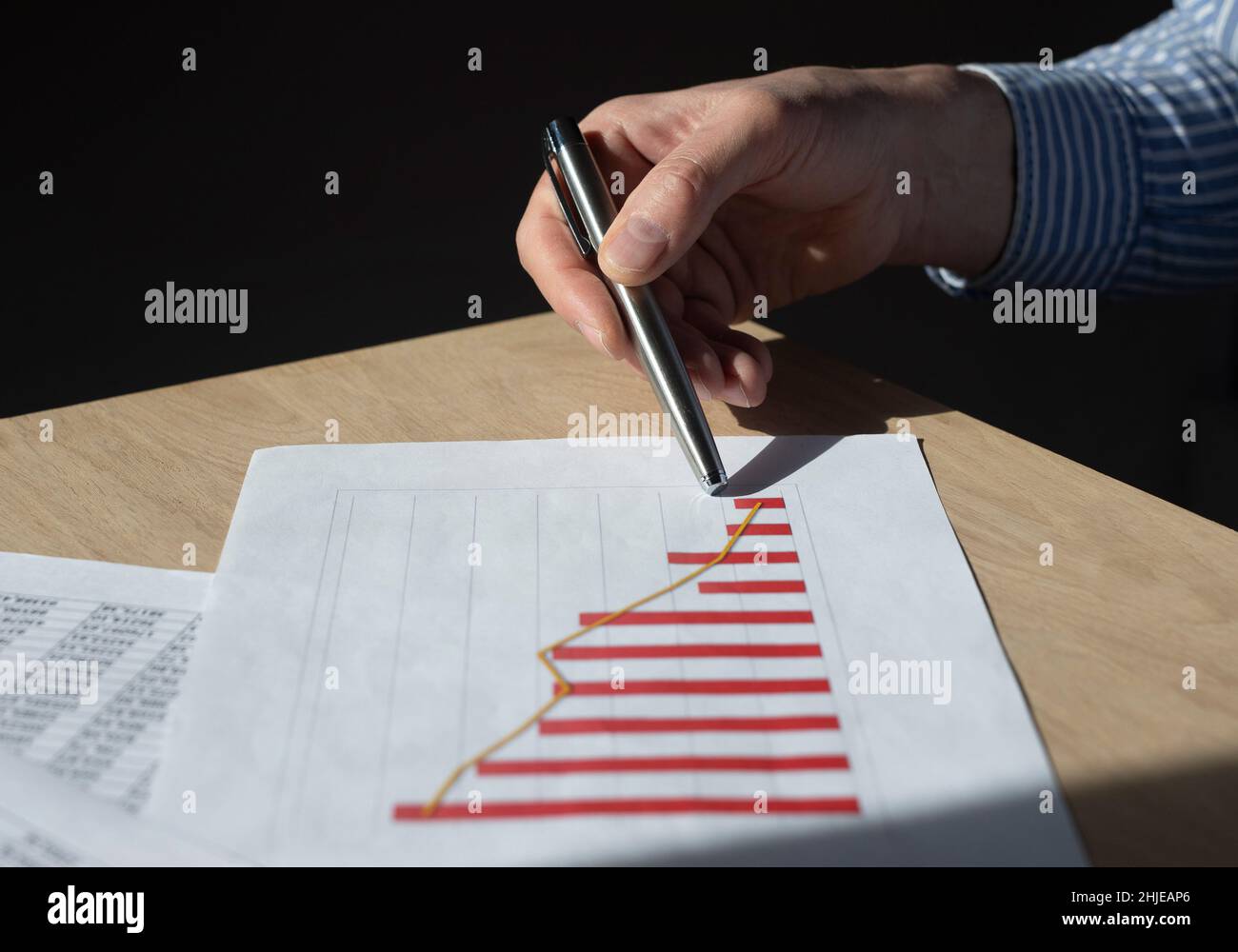Financial crisis concept. Male hand showing at graph with falling trend ...
