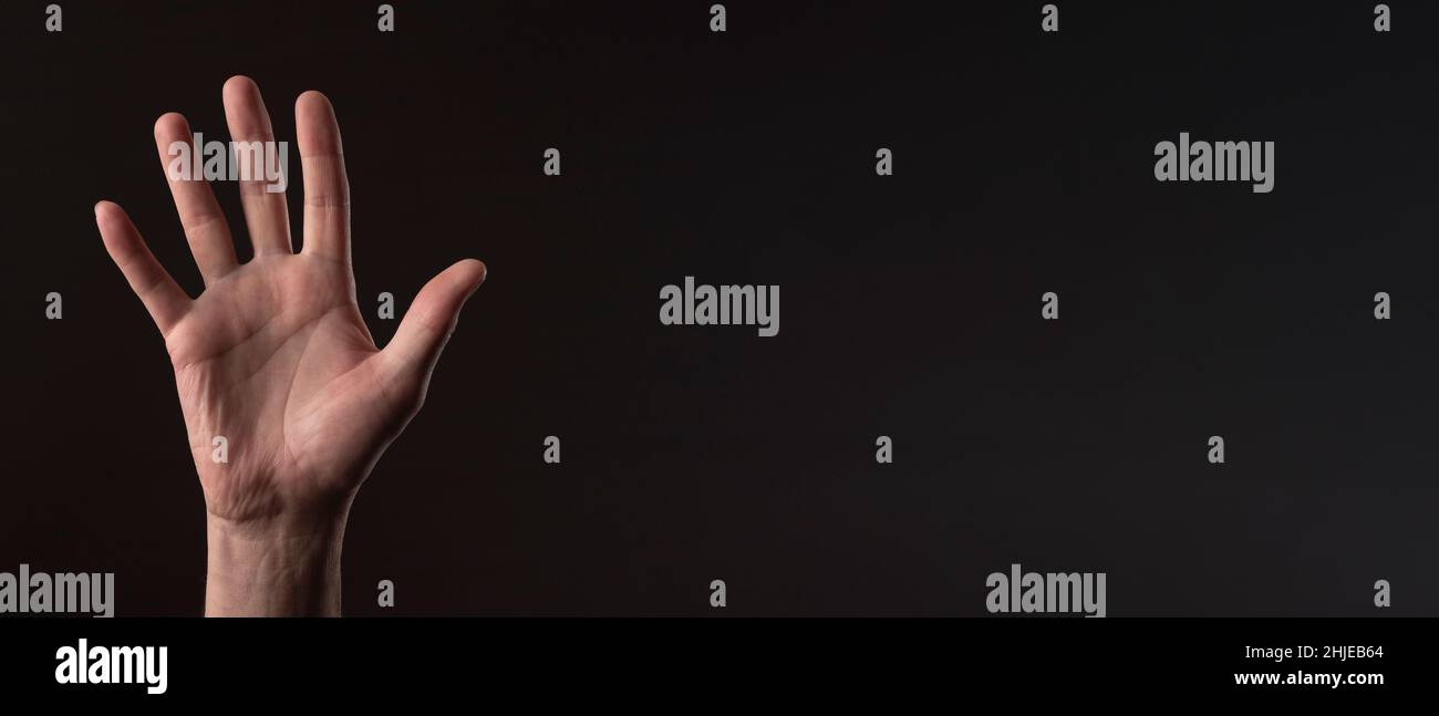 Male hand palm gesturing hello or hi over black background. greeting ...