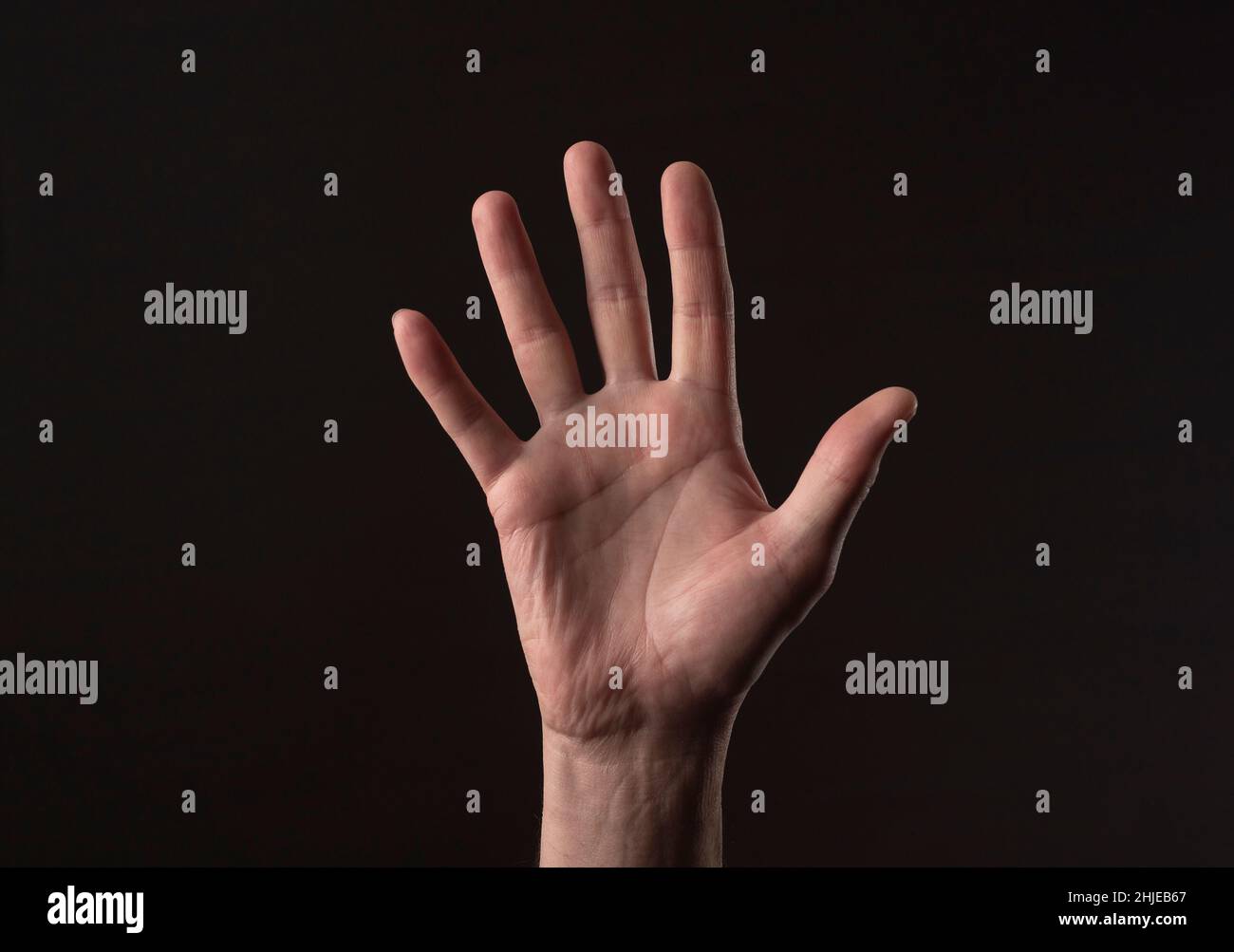 Male hand palm gesturing hello or hi over black background. greeting ...