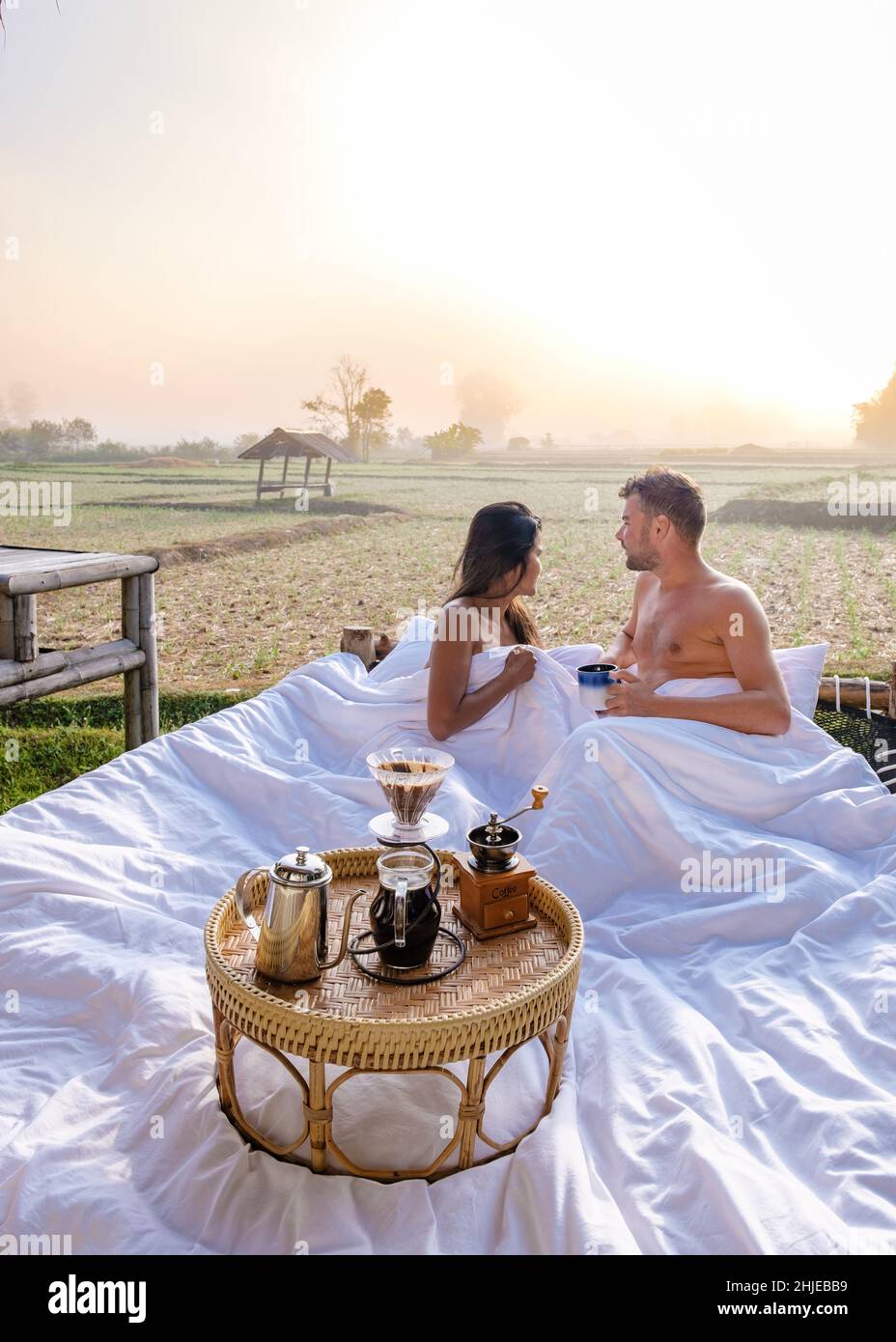 Adult couple waking up in bed hi-res stock photography and images - Alamy