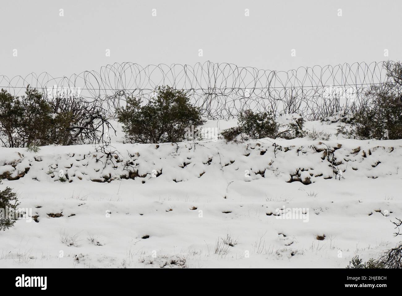 A barbed wire fence, separating between israeli and palestinian ...