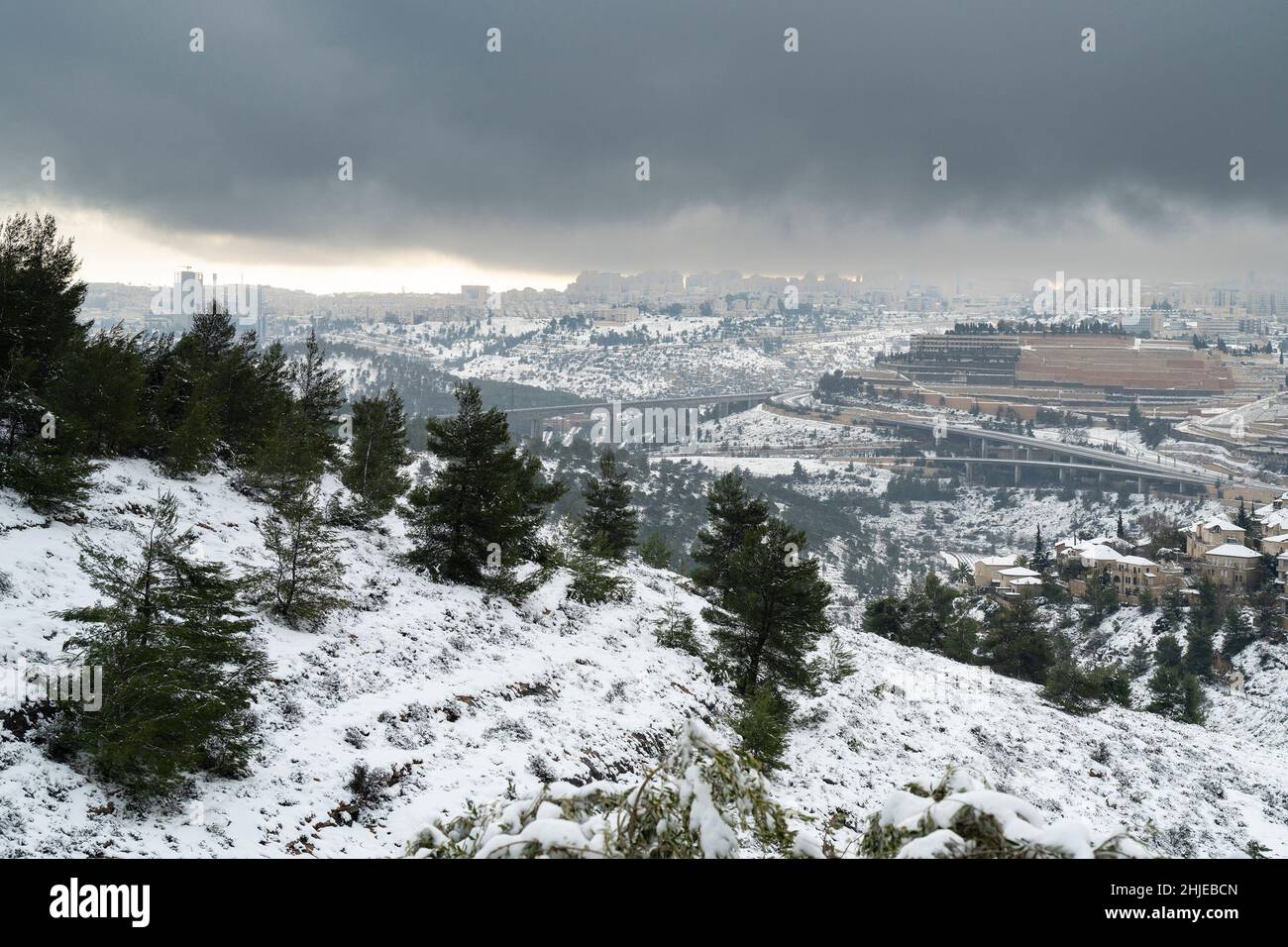 A stormy, hazy sunrise over the snow covered Jerusalem, Israel, and the ...