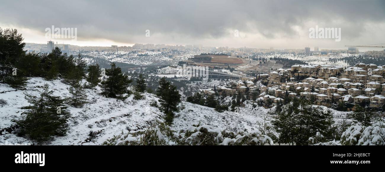 A stormy, hazy sunrise over the snow covered Jerusalem, Israel, and the ...