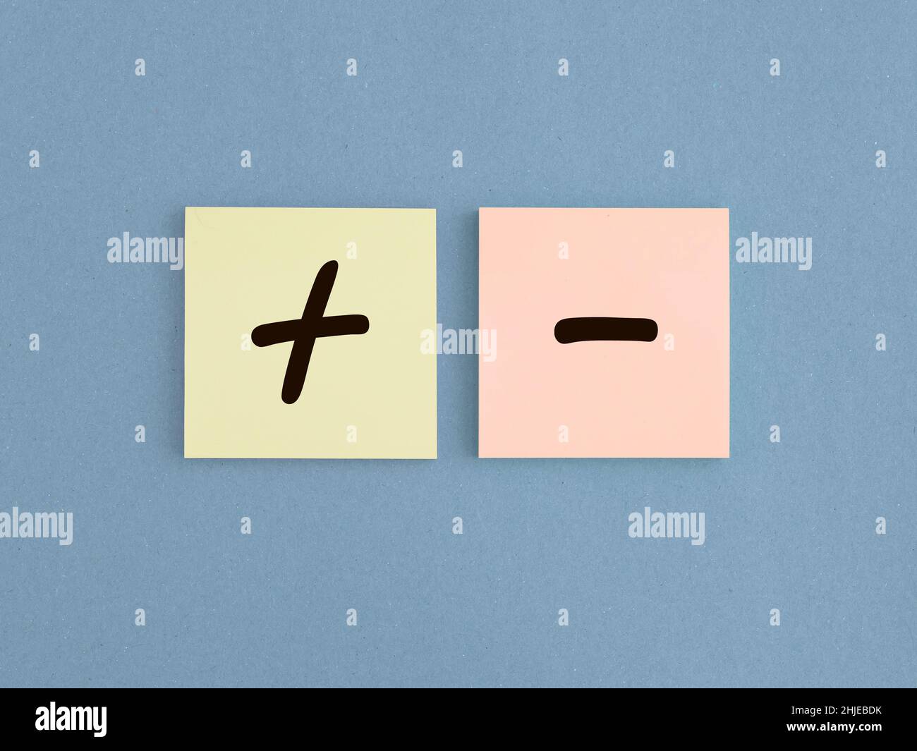 Plus and minus signs on paper. Concept of positive and negative, pros ...