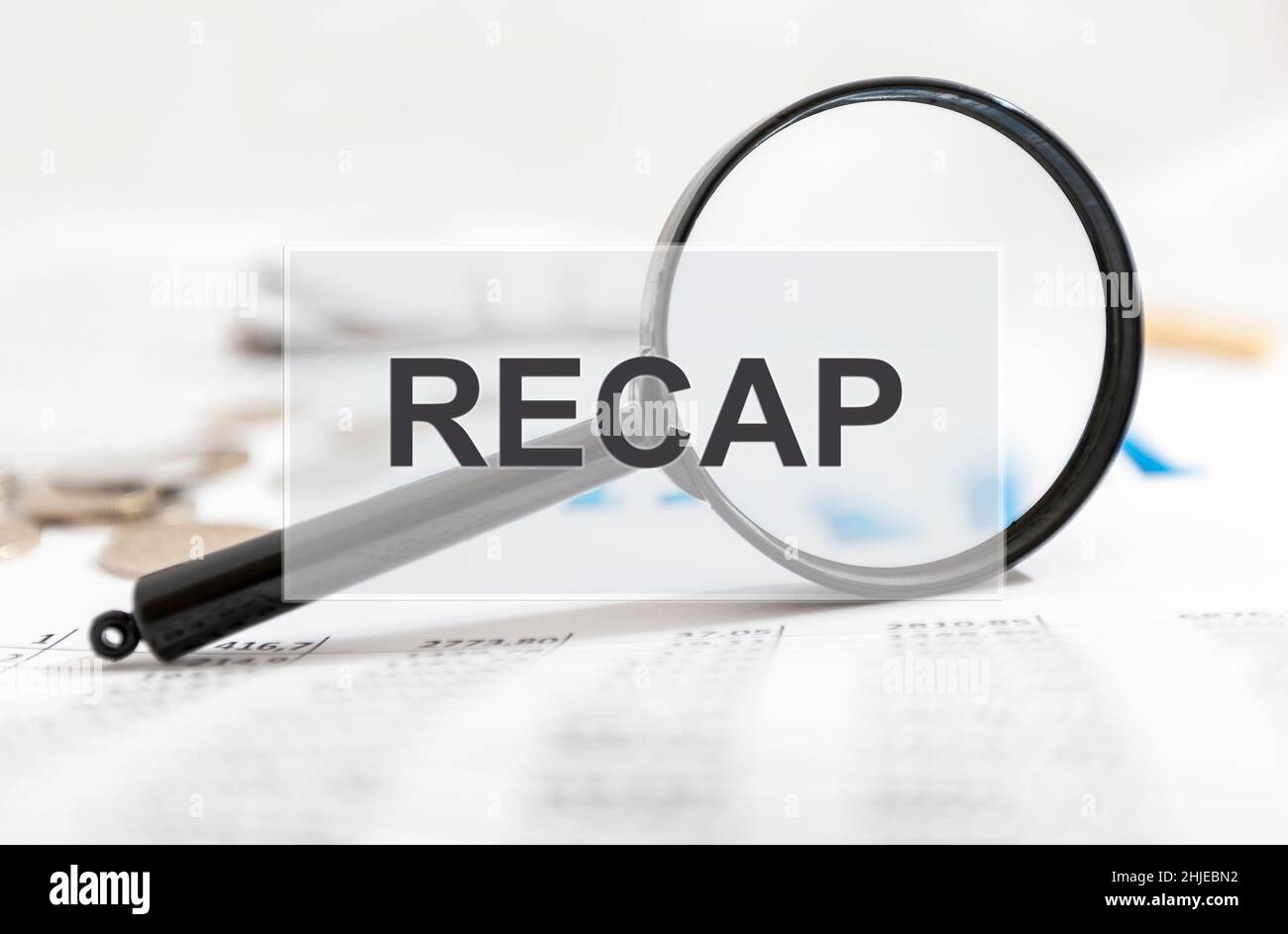 Recap word over image with financial documents and magnifying glass ...