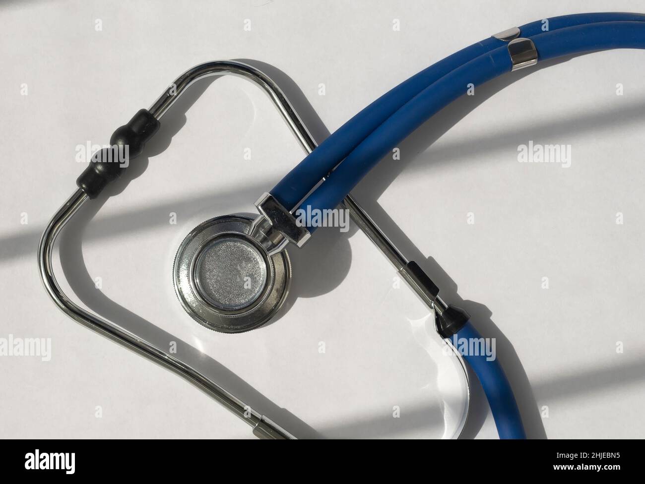 Above view of metal stethoscope on white background with daylight ...