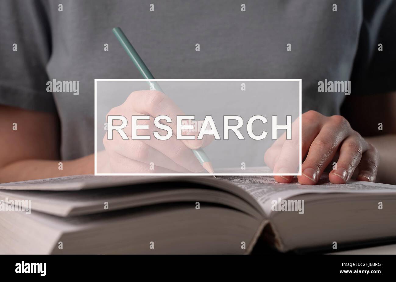 Research text on image with book sand scientist hands Stock Photo - Alamy
